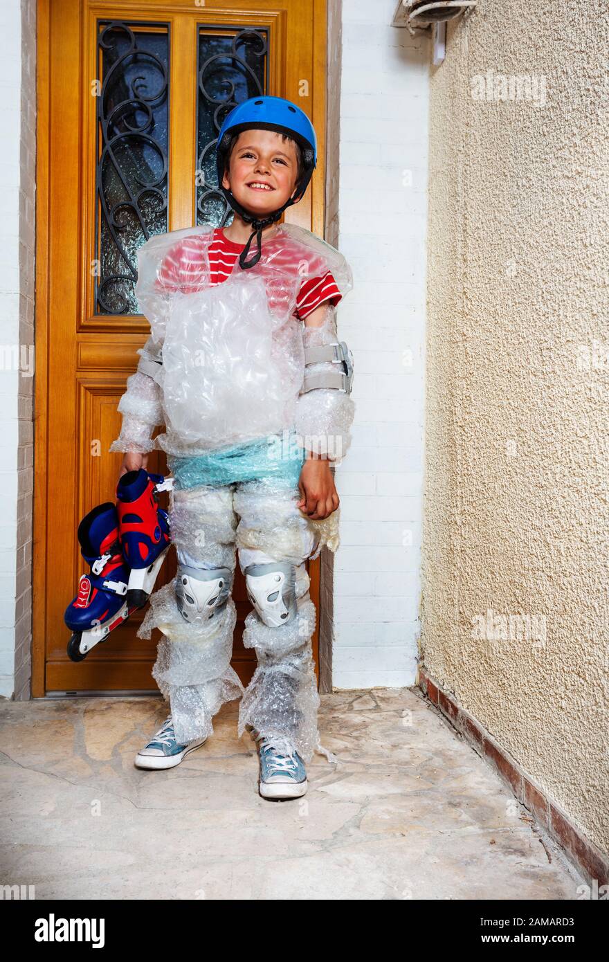 Kid hold rollerblades ball wear super safe bubble wrap and helmet have ...