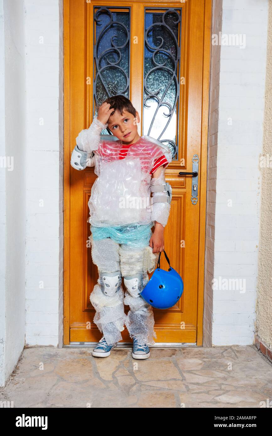 Puzzled sad boy with helmet wear super safe bubble wrap have ...