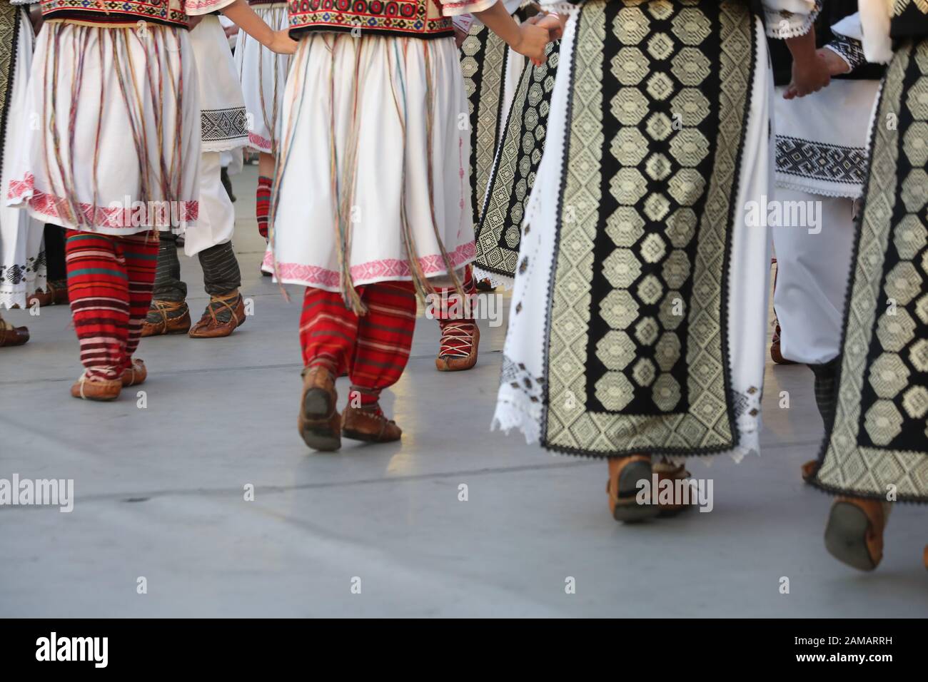 Professional dancers of the Timisul Folklore Ensemble hold hands in a ...