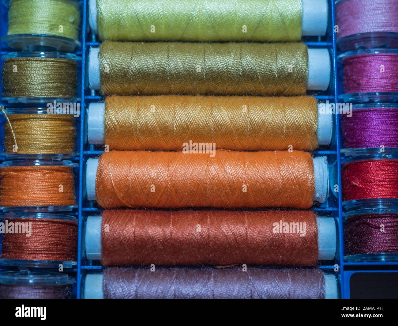 A lot of sewing colored thread. Thread reels. Colorful threads in the ...