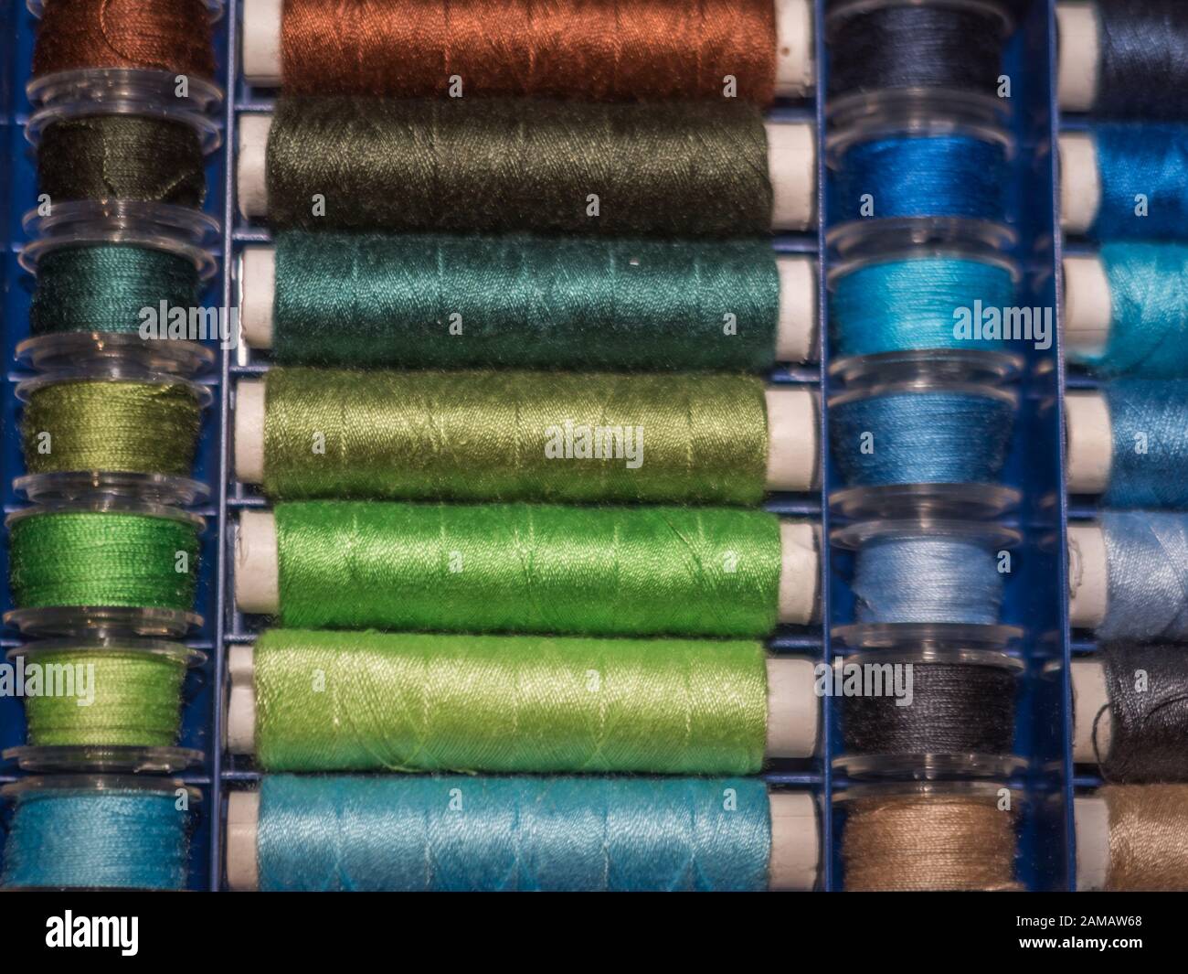 A lot of sewing colored thread. Thread reels. Colorful threads in the ...