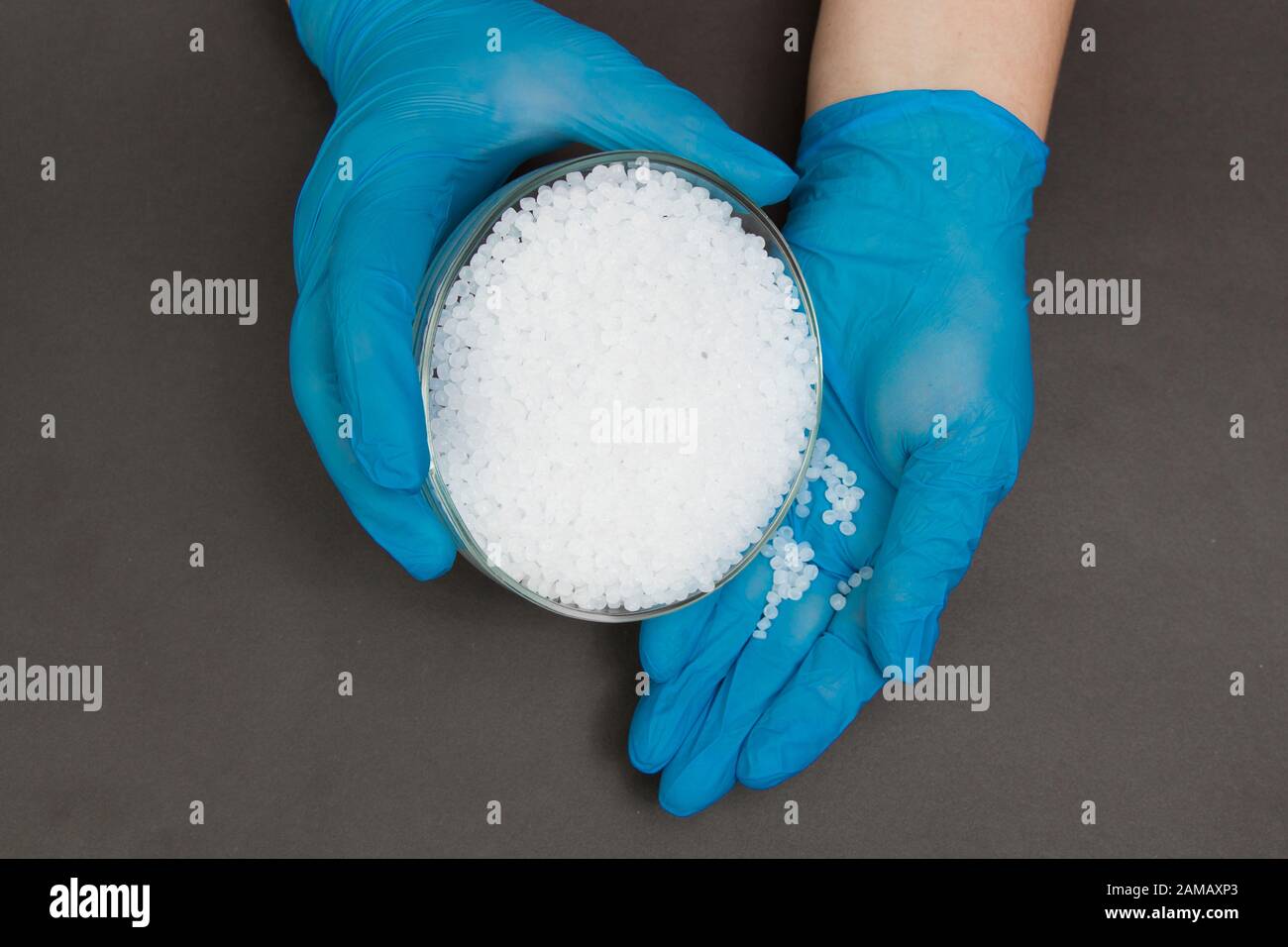 Plastic granules . Polypropylene, polyethylene pellets in hands with ...