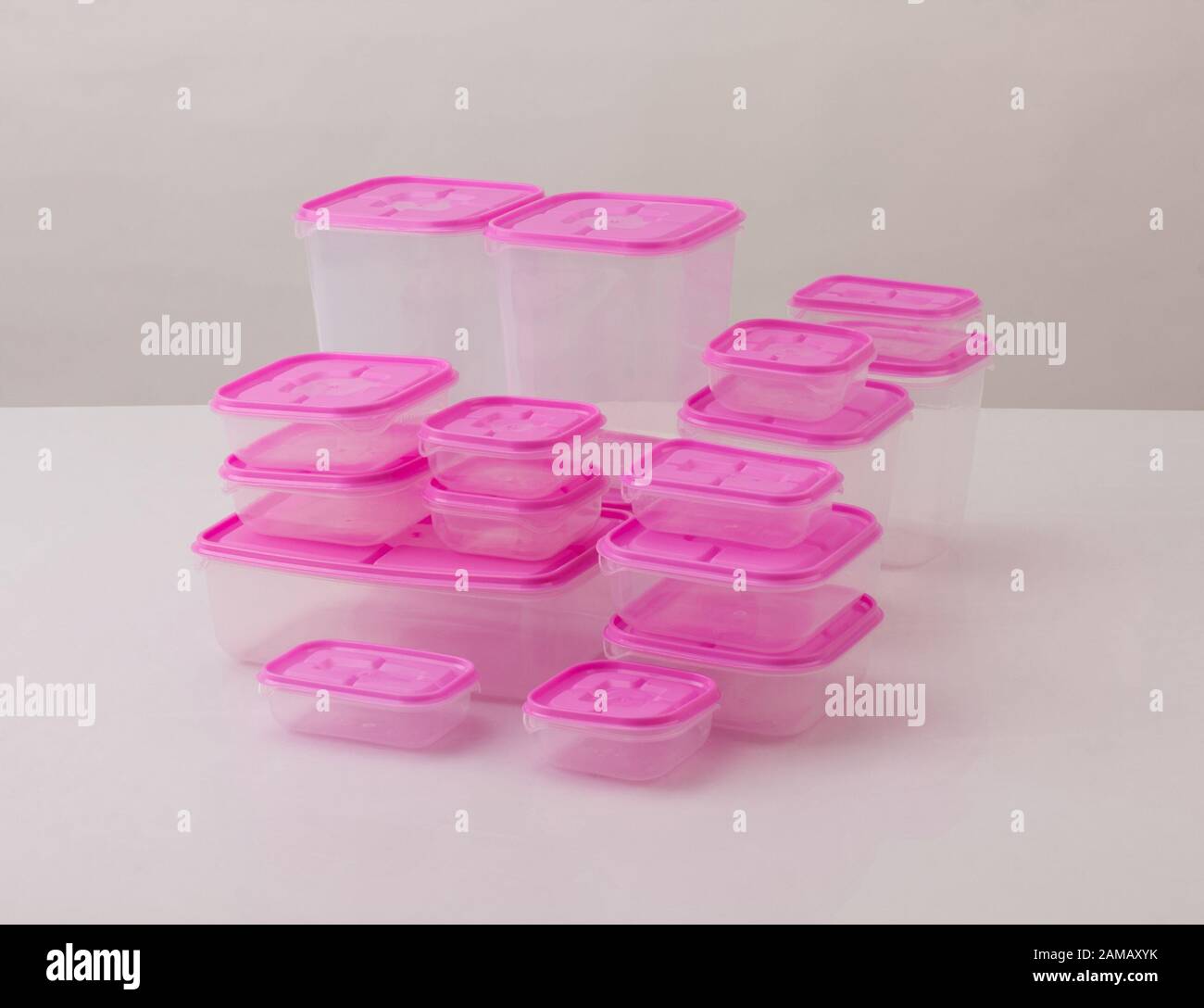 set of pink plastic boxes isolated on white background Stock Photo - Alamy