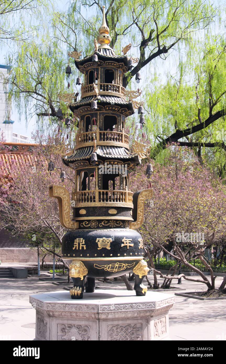 An incense burner within the Jile Temple complex on a sunny spring day ...