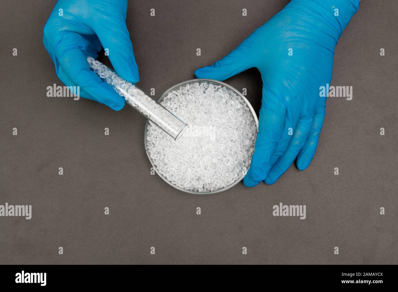 Plastic granules . Polyethylene pellets and hands with gloves. Quality ...