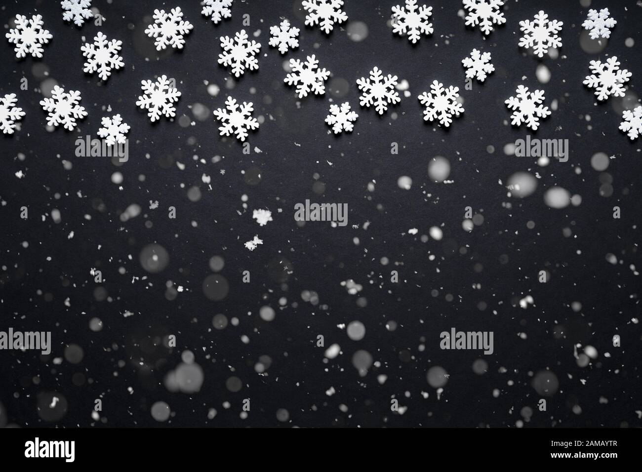 Snow flake texture and falling snow on black background Stock Photo - Alamy