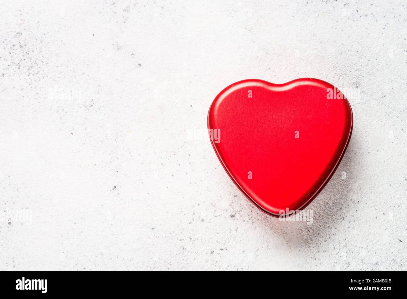 Red heart on white table top view Stock Photo - Alamy