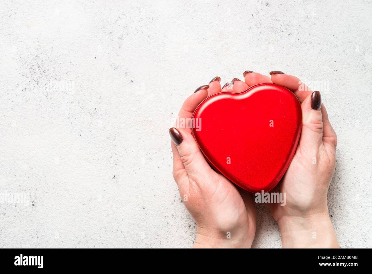 Red heart on white table top view Stock Photo - Alamy