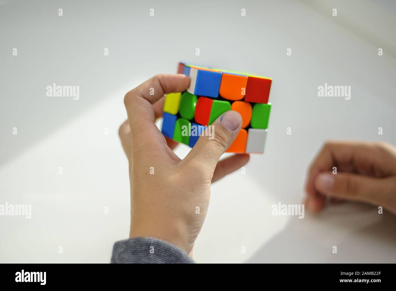 Child solving rubiks cube hi-res stock photography and images - Alamy