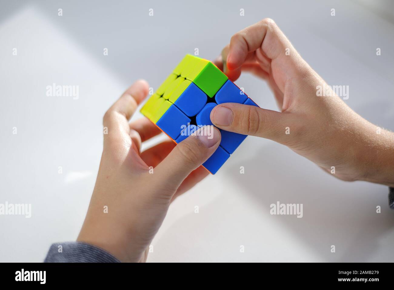 Child solving rubiks cube hi-res stock photography and images - Alamy