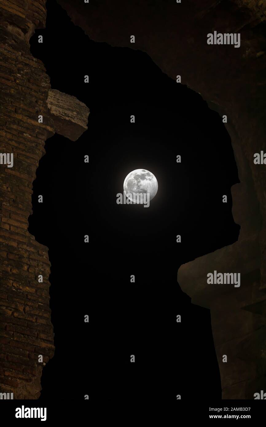 Full moon during the shadowy eclipse, in the frame of an arch of an ...