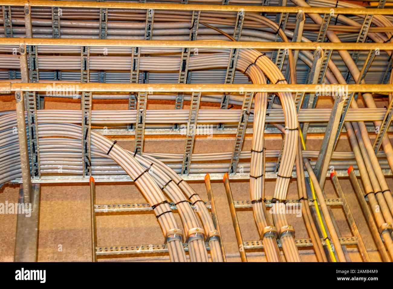 Electrical grey cables mounted in a rack for power supply in a ...