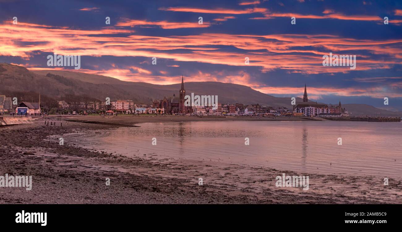 Sunset over the town of Largs with its Church Steeples and pierhead ...