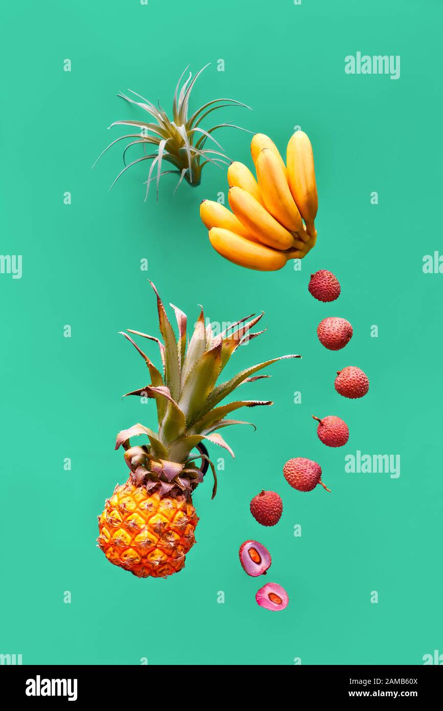 Assortment of tropical fruits, levitation on green background ...