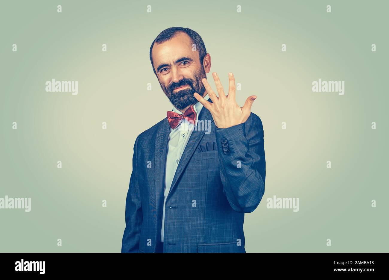 Bearded man shows five fingers gesture with hand isolated on green ...