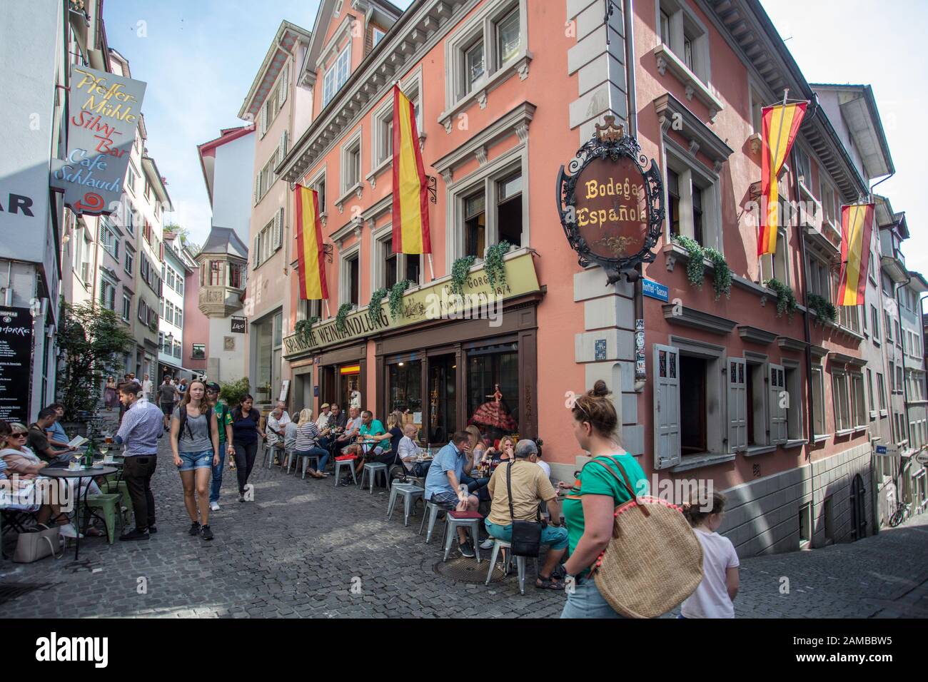 People seated outside a Spanish restaurant have lunch on tables. Zurich ...