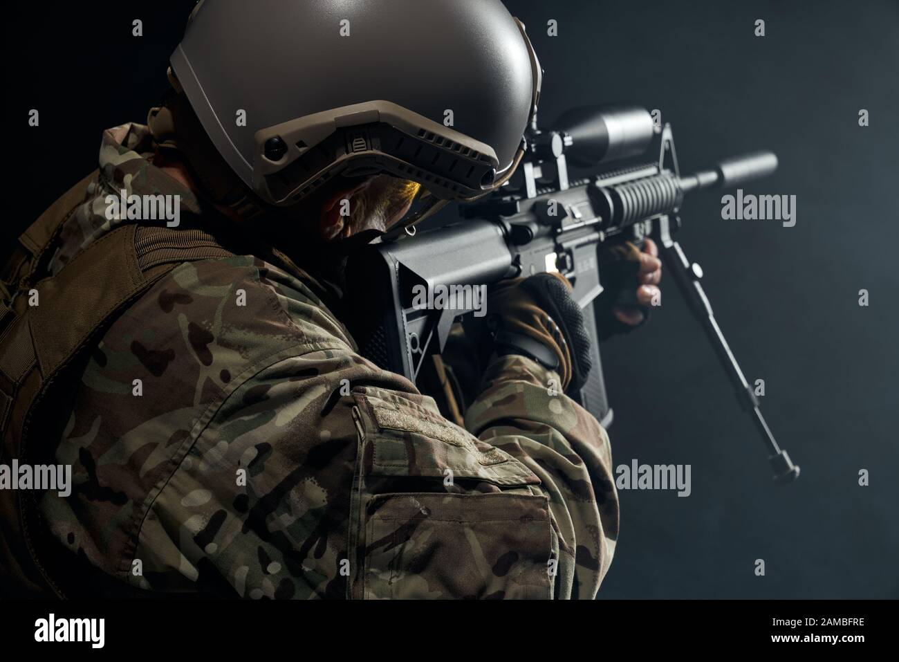 Side close up of old military officer holding sniper rifle and aiming ...