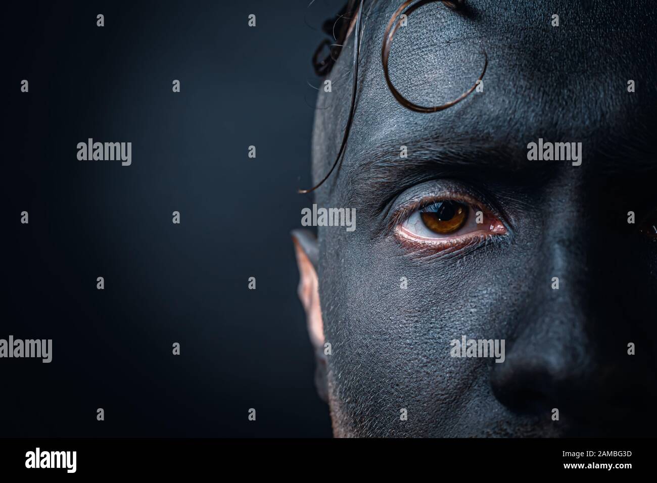 The dirty face of a working miner. Close-up portrait of a black face in ...
