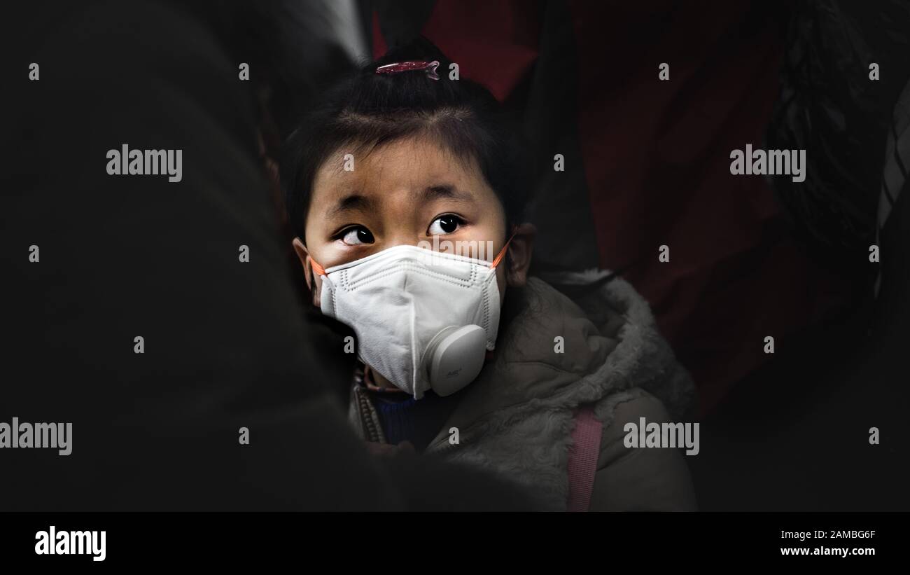 Young girl wearing a white pollution mask in Beijing, China Stock Photo ...