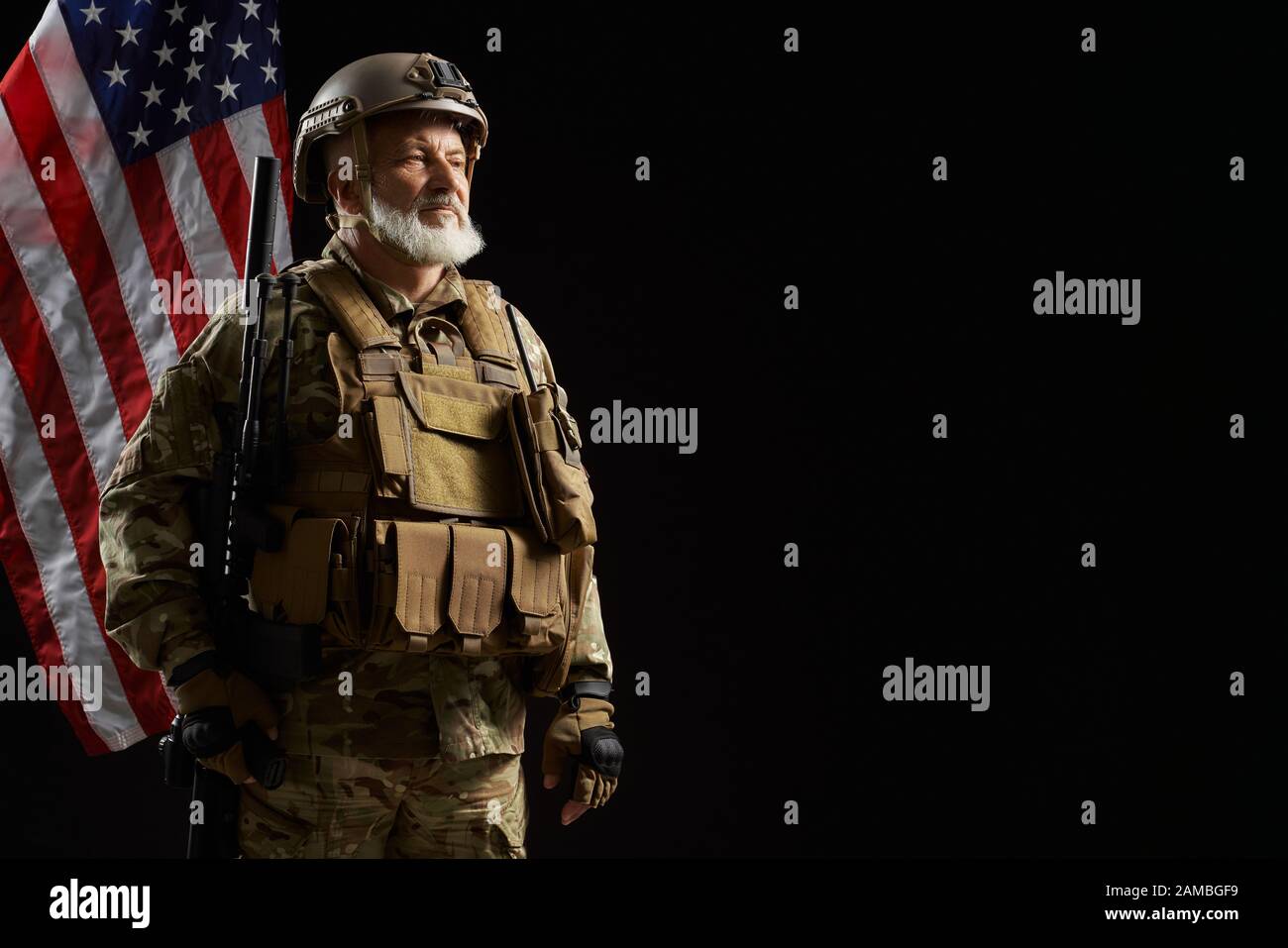 Front view of military officer holding sniper rifle and proudly looking ...