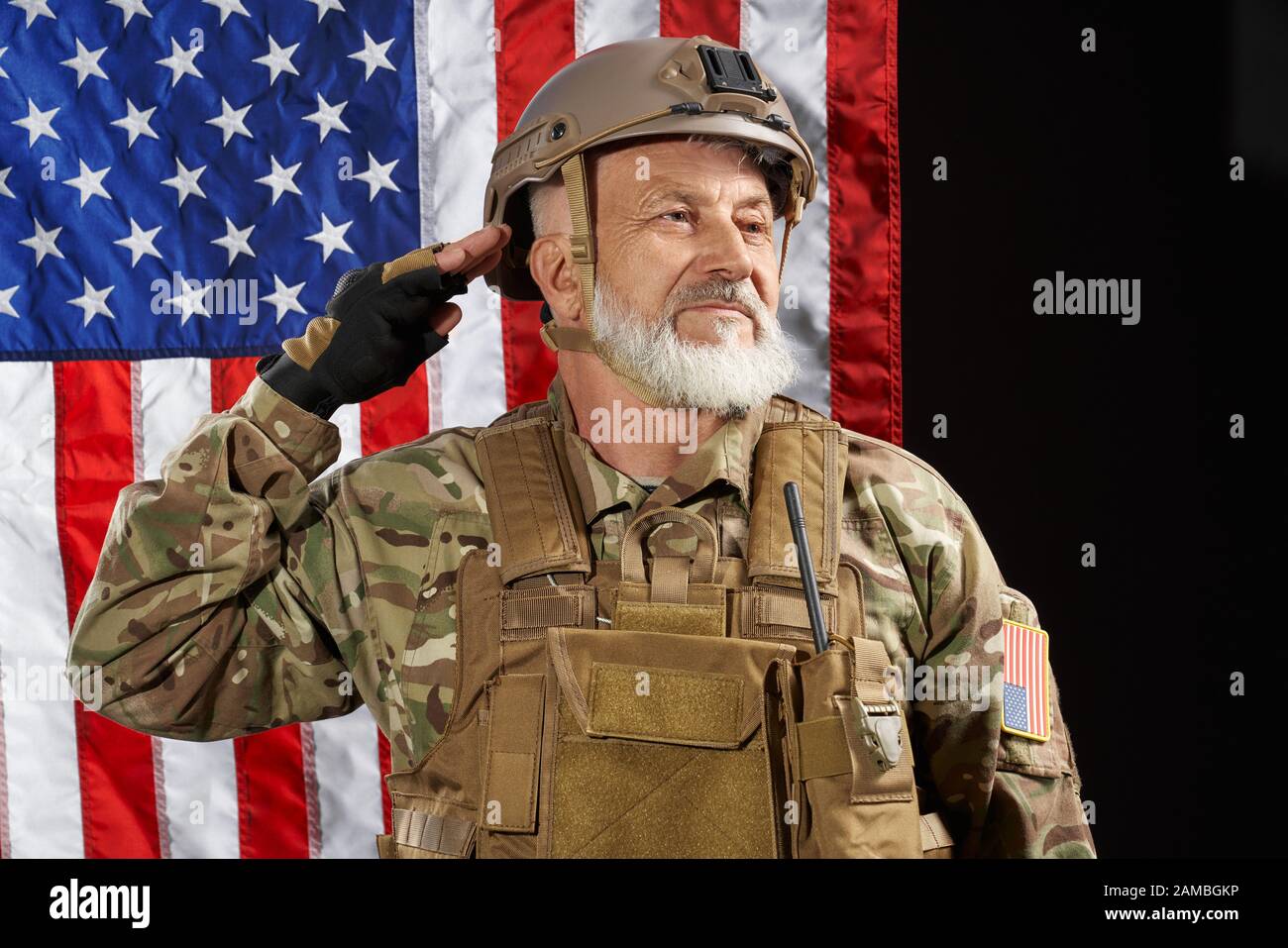 Front view of old military officer saluting and looking away. Portrait ...