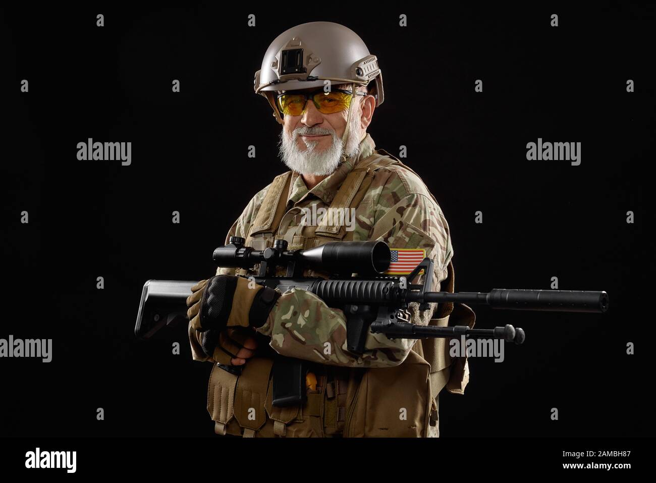 Front view of old smiling military officer holding sniper rifle and ...