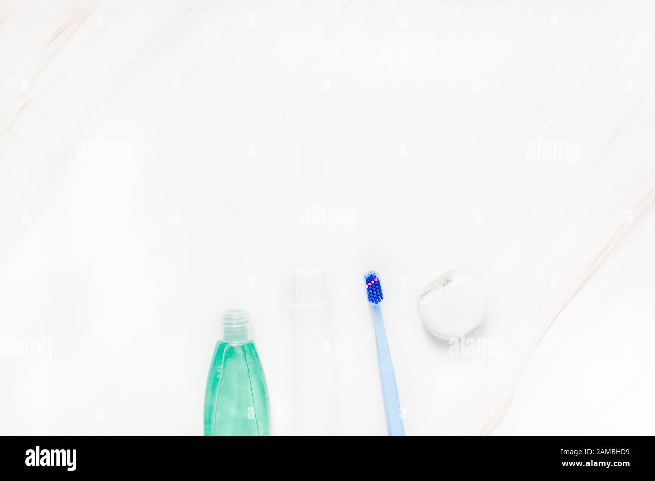 Teeth hygiene and oral dental care products on white marble table ...