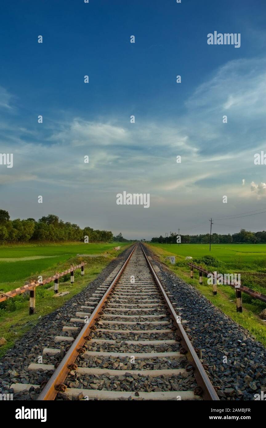 Infinity Rail tracks on the gravel path through the paddy fields Stock ...