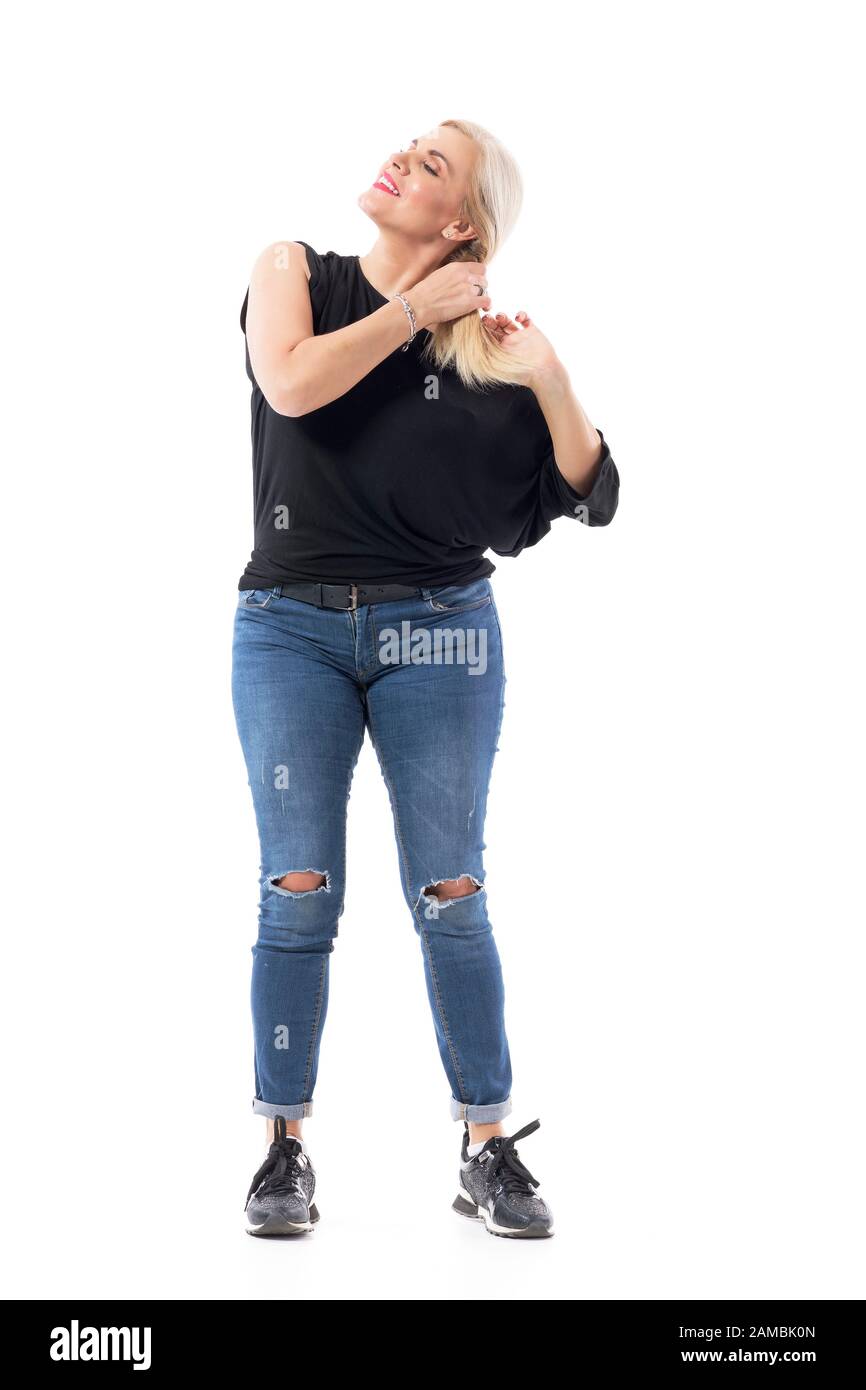 Happy carefree relaxed casual middle age beautiful woman tying hair in ...