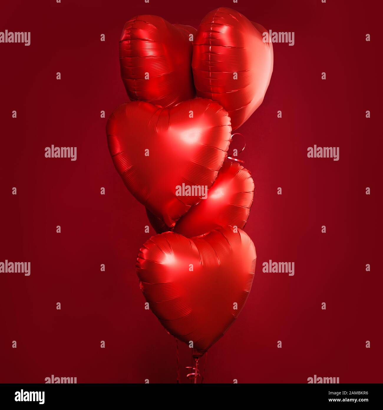 Perfect red heart balloons composition on bright red card background ...