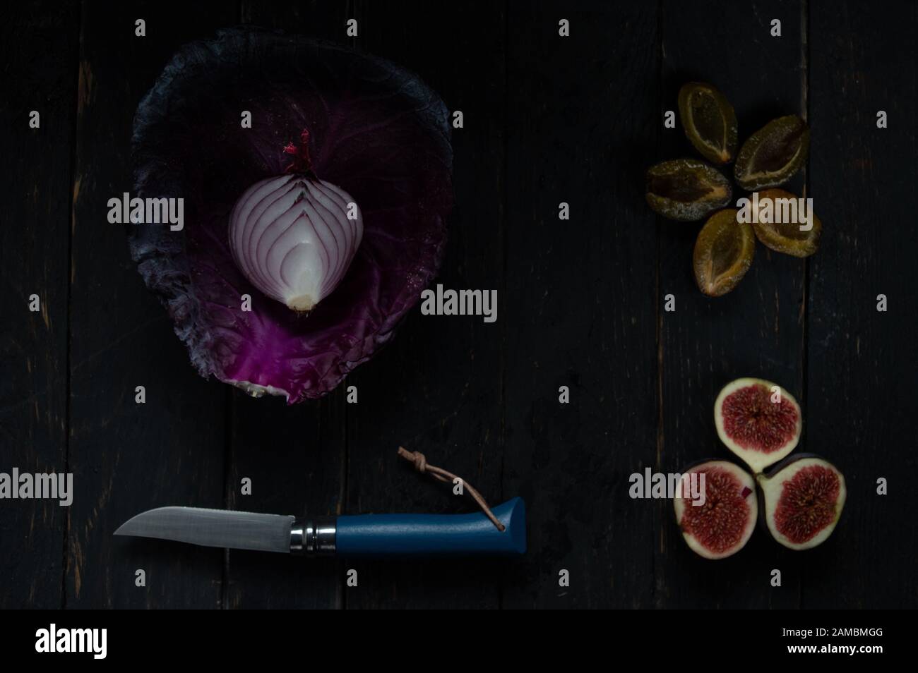 Blue vegetables and fruits. Blue kitchen knife. Sliced vegetables and ...