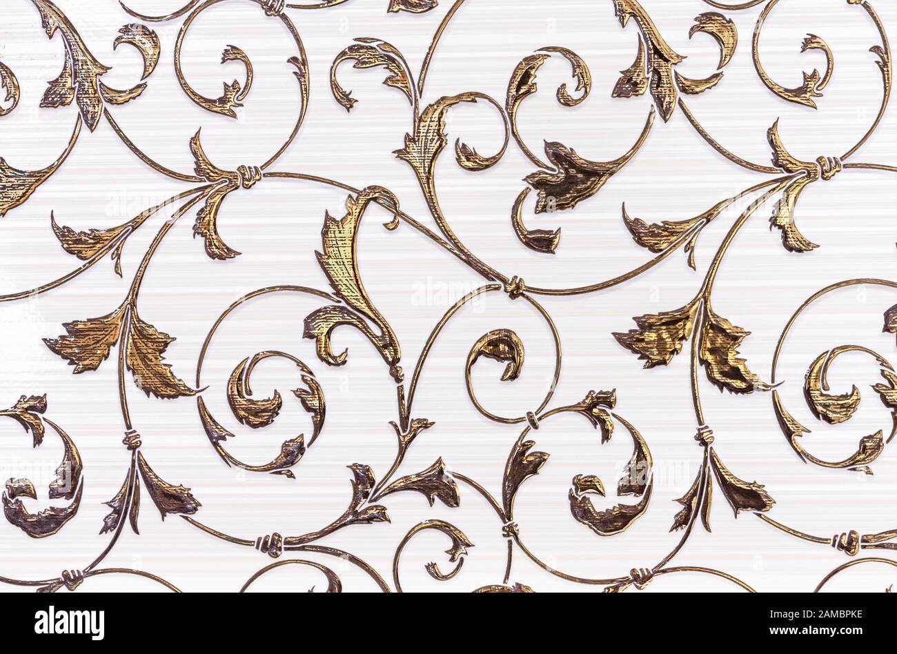 White porcelain tiles with a gold floral ornament. Ceramic tiles with ...