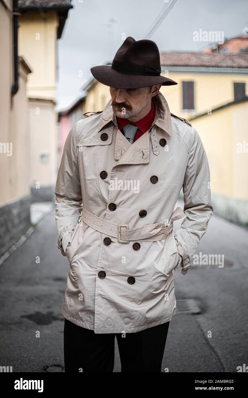 Detective walking in the city slums Stock Photo - Alamy