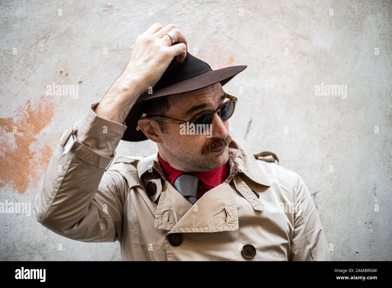 Detective walking in the city slums Stock Photo - Alamy