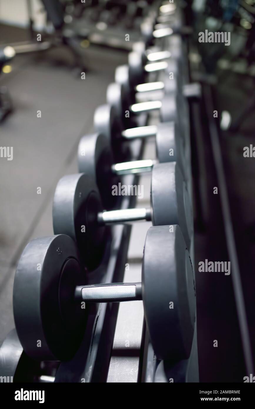 Detail of a dumbbells stand in a gym Stock Photo - Alamy