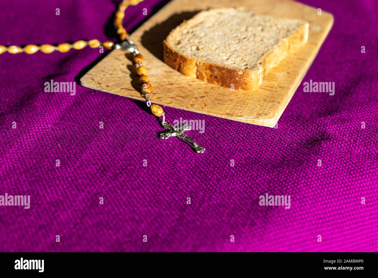 bread and rosary beads lent concept before easter Stock Photo - Alamy