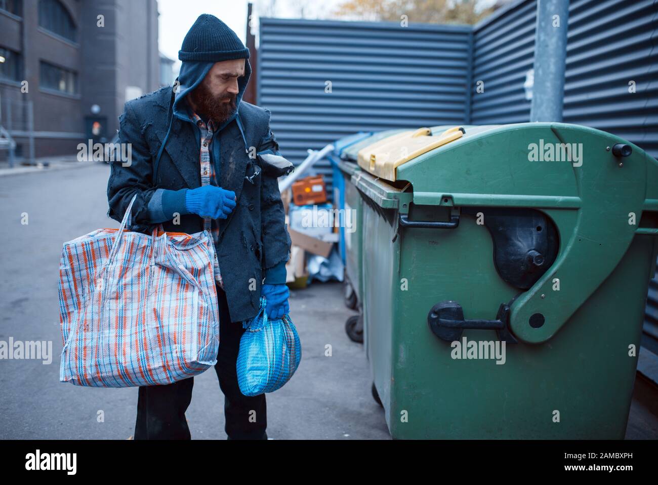 Homeless man searching in garbage hi-res stock photography and images ...