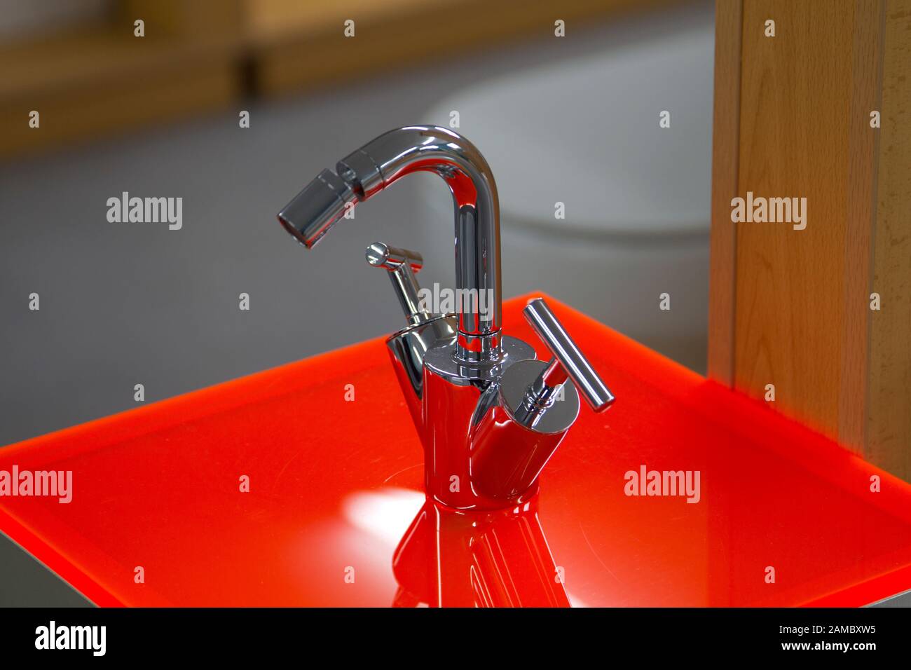 chrome steel tap on orange silver glazed Stock Photo - Alamy