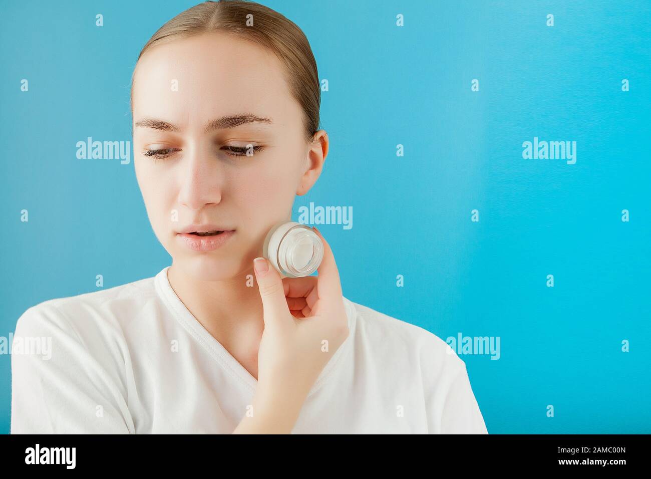 Portrait Of Joyful Girl Covering Her Eye By A Cream Can She Is Looking