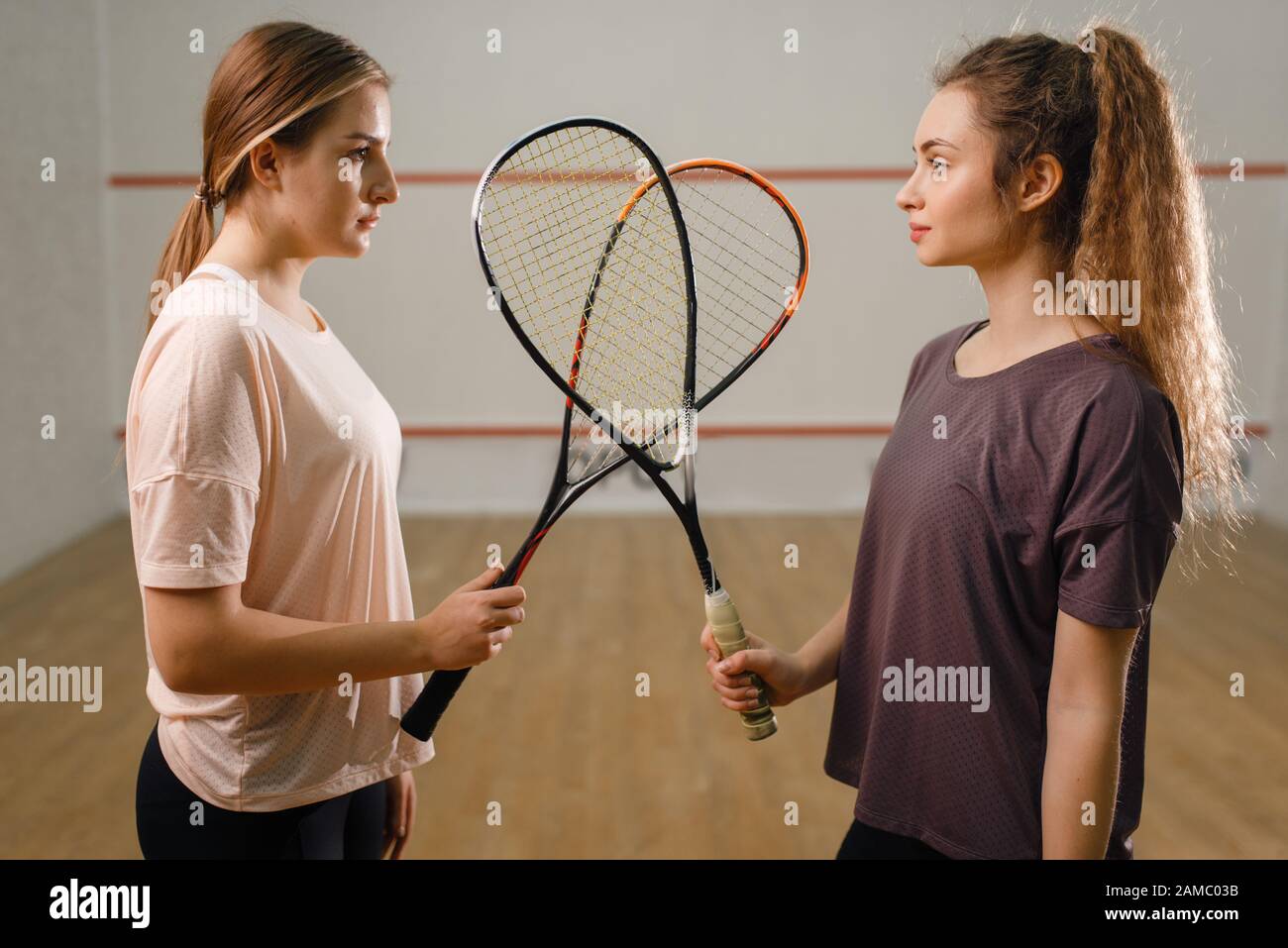 Players with squash rackets stands face to face Stock Photo - Alamy