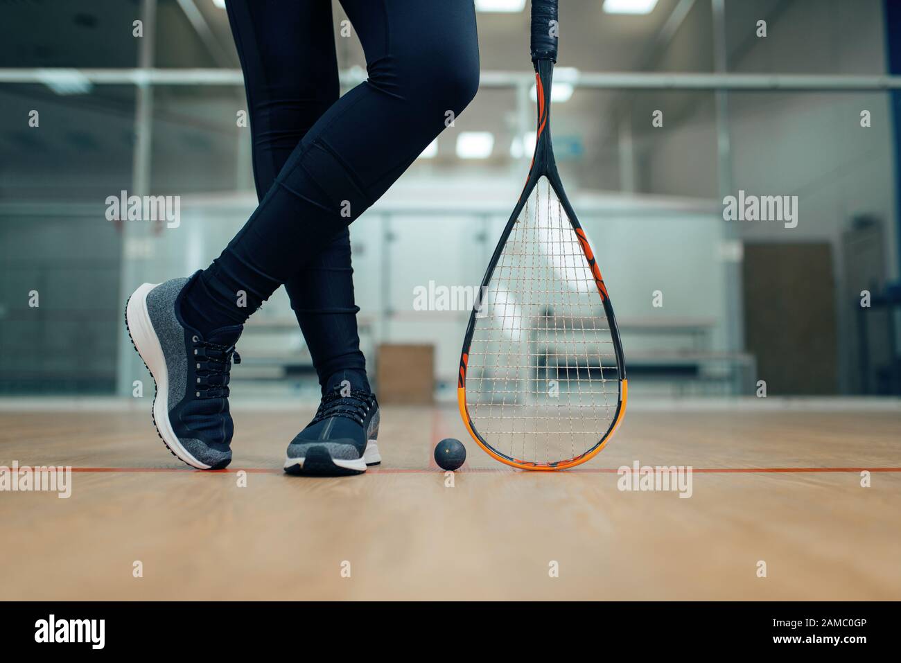 Female player legs, squash racket and ball Stock Photo - Alamy