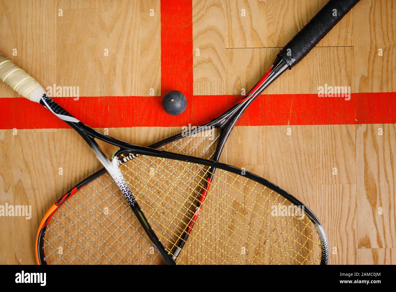 Squash rackets and ball on court floor, top view Stock Photo - Alamy