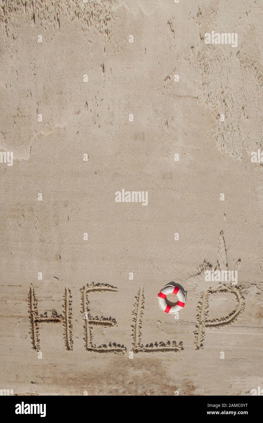 Help me the inscription and lifebuoy on the sand. Please help me. On a ...