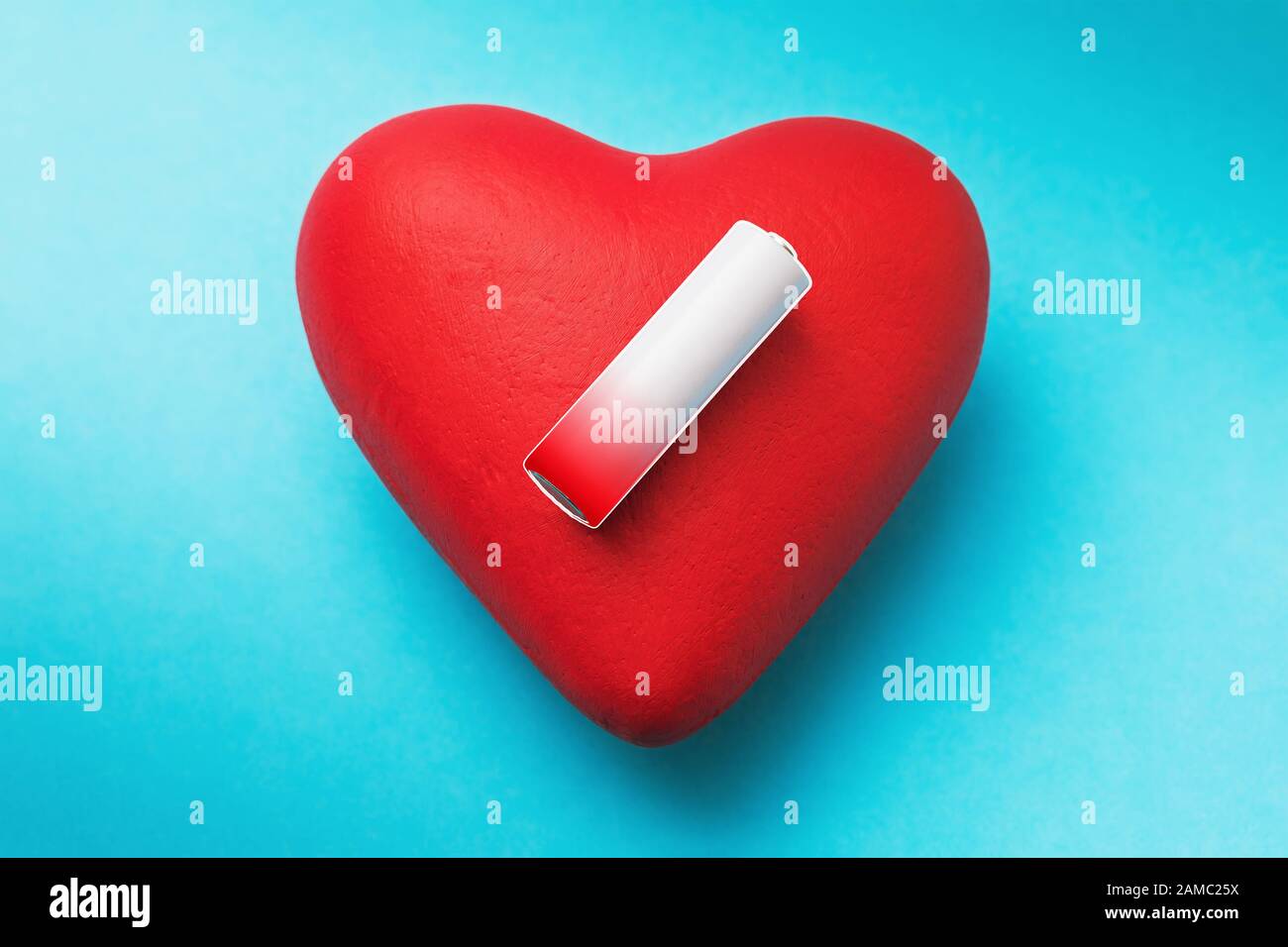 Low battery and heart on a blue background, top view. Poor Health ...