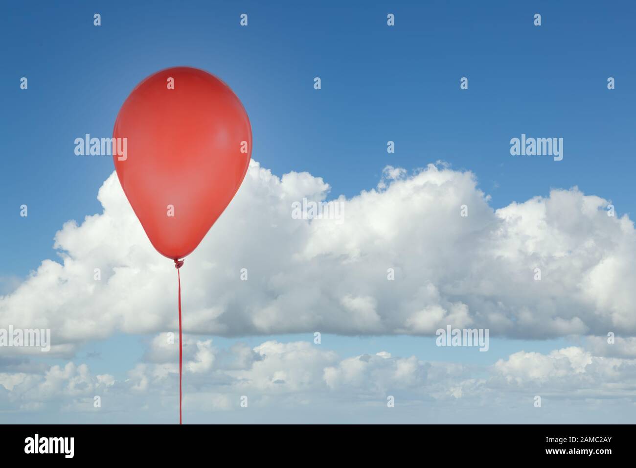 Red balloon isolated at blue sky with clouds Stock Photo - Alamy