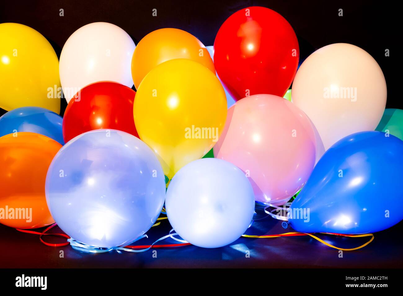 Colorful balloons illuminated with LED against dark background Stock ...