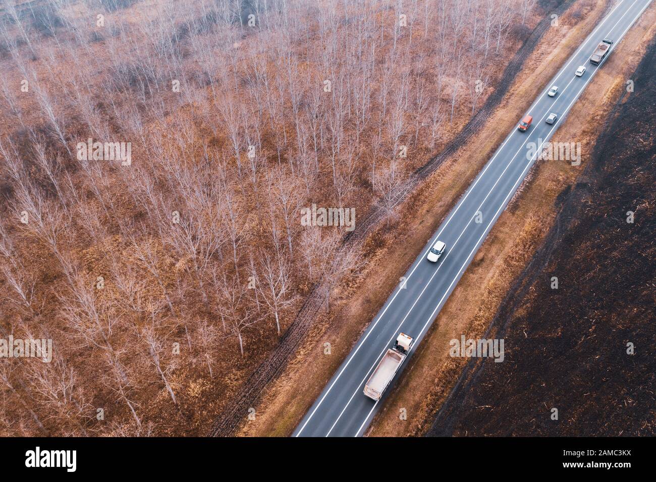 Aerial view of transit road traffic with cars and trucks in winter ...