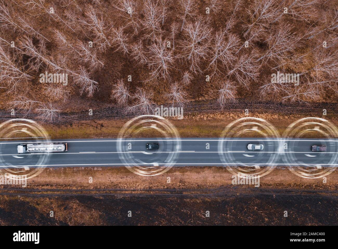 Aerial view of autonomous self-driving car on road through countryside ...