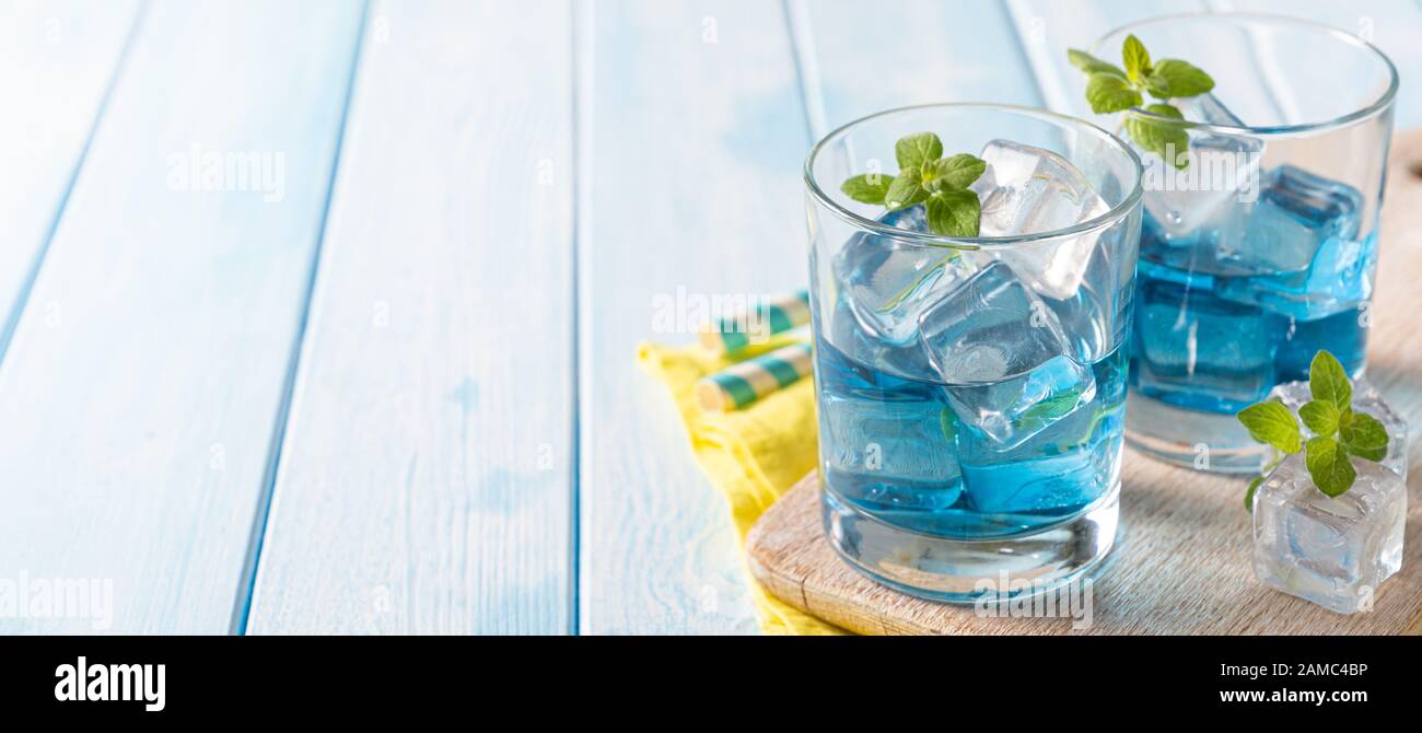 Blue lemonade in glasses on wood background Stock Photo - Alamy