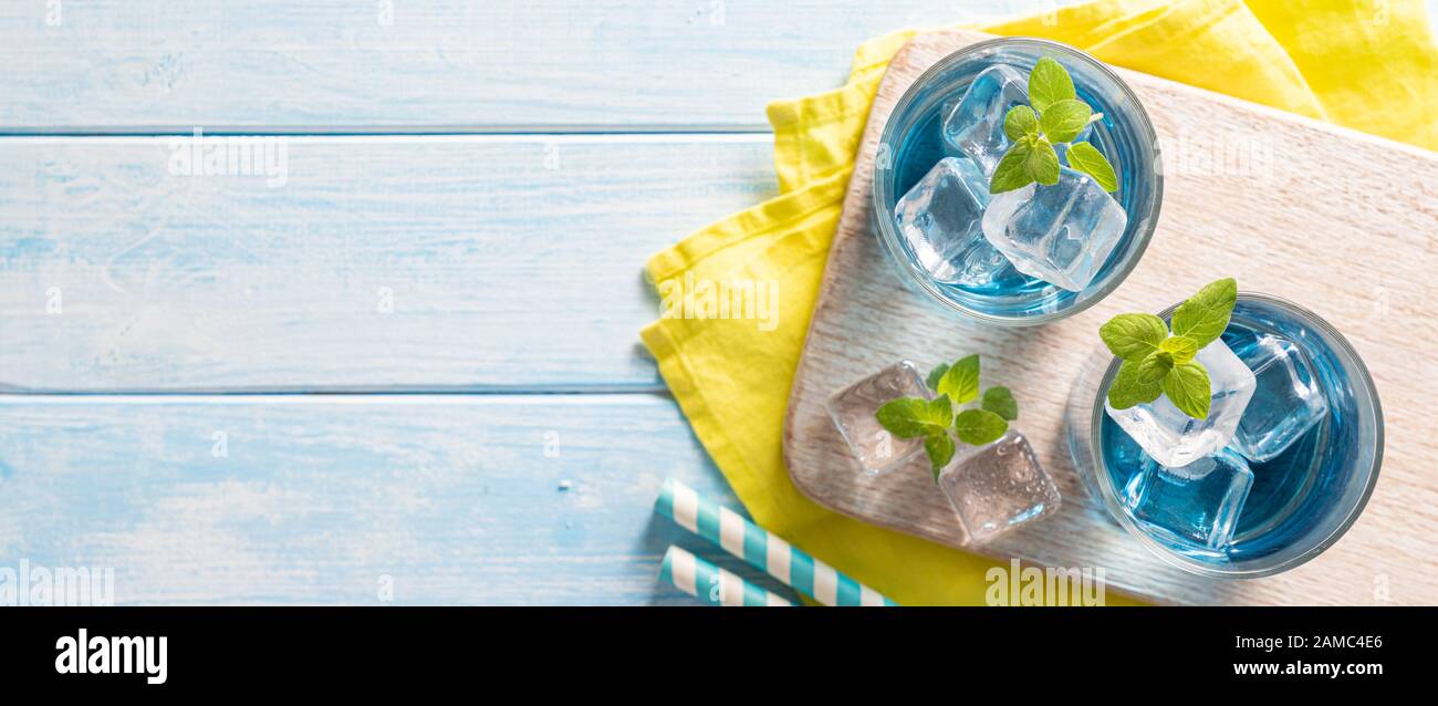 Blue lemonade in glasses on wood background Stock Photo - Alamy